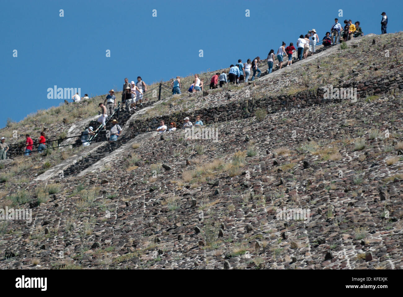 Crowd of tourists climbing the top of Pyramid of the Sun and Pyramid of ...