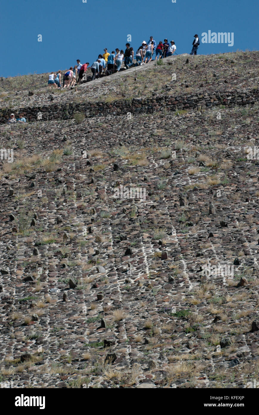 Crowd of tourists climbing the top of Pyramid of the Sun and Pyramid of ...
