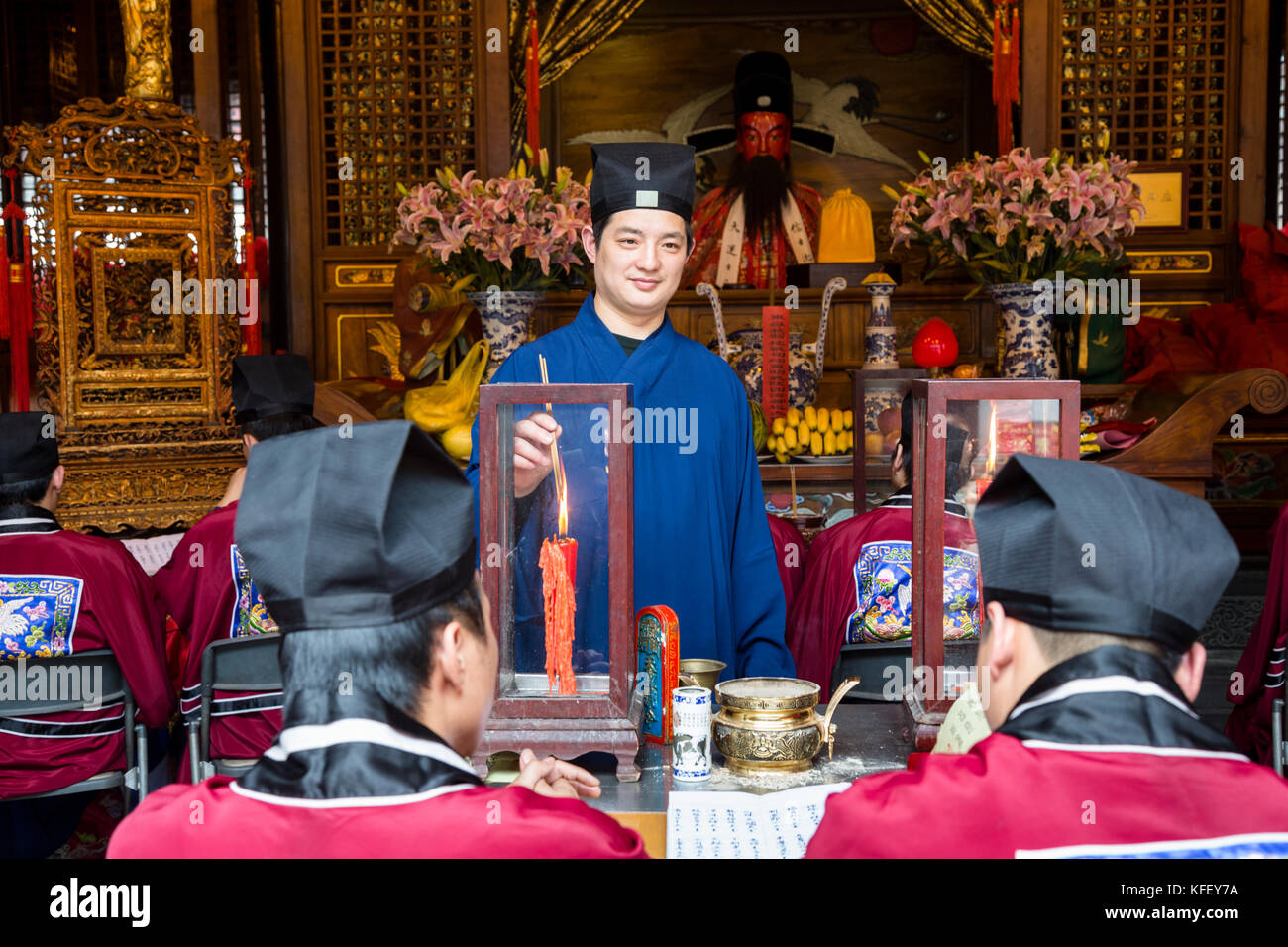 The monk lights a candle in one of the temple complexes in Shanghai ...