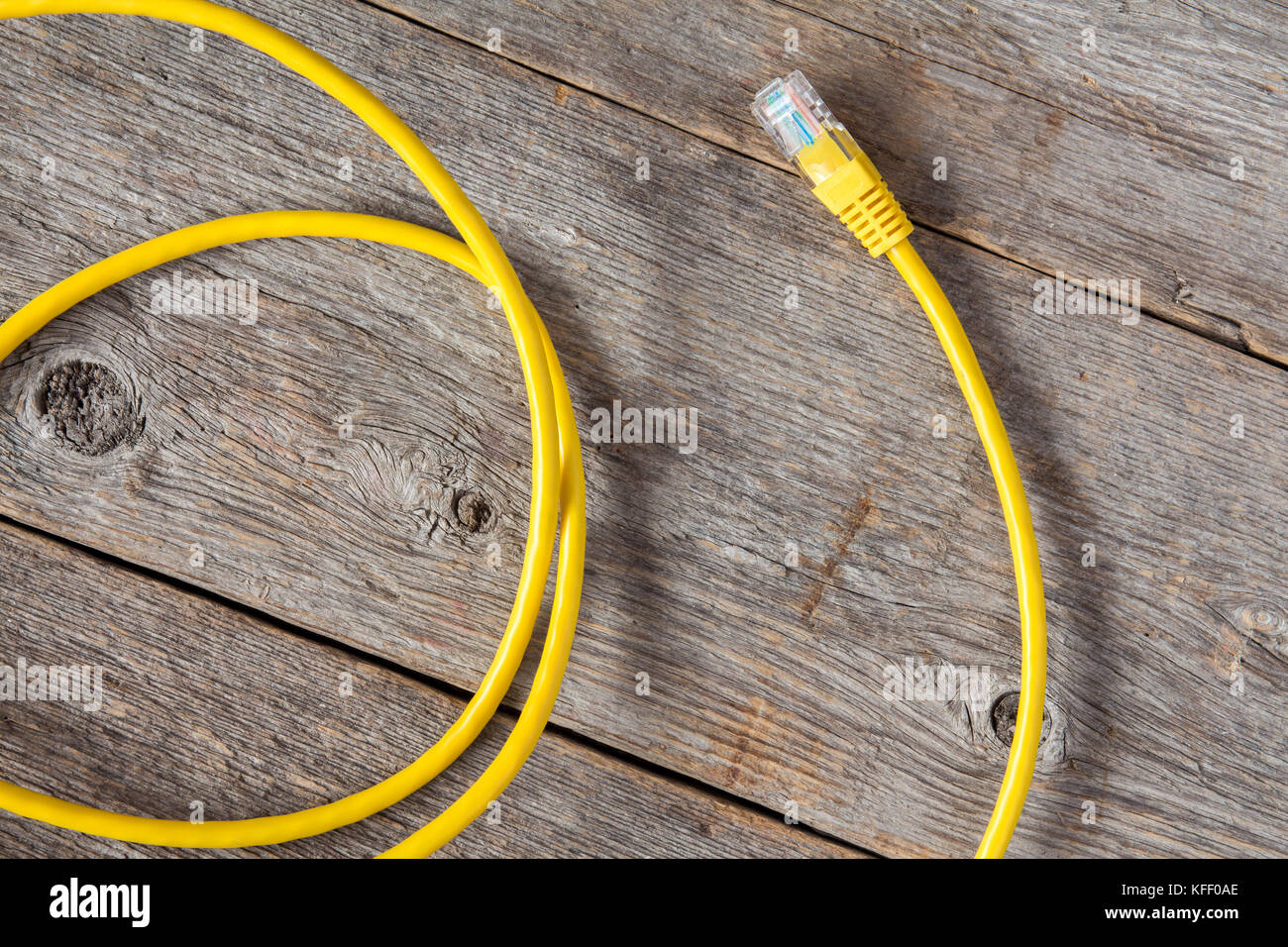 Yellow internet cable on the old wooden background Stock Photo - Alamy