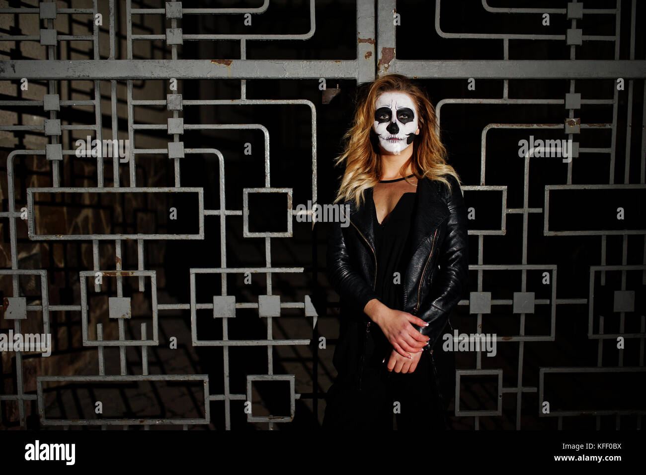 Halloween skull make up girl wear in black at night street of city ...