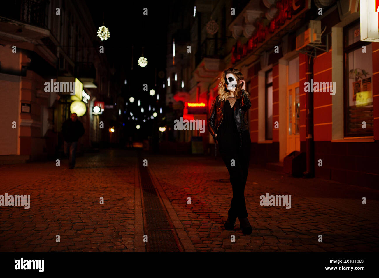 Halloween skull make up girl wear in black at night street of city ...
