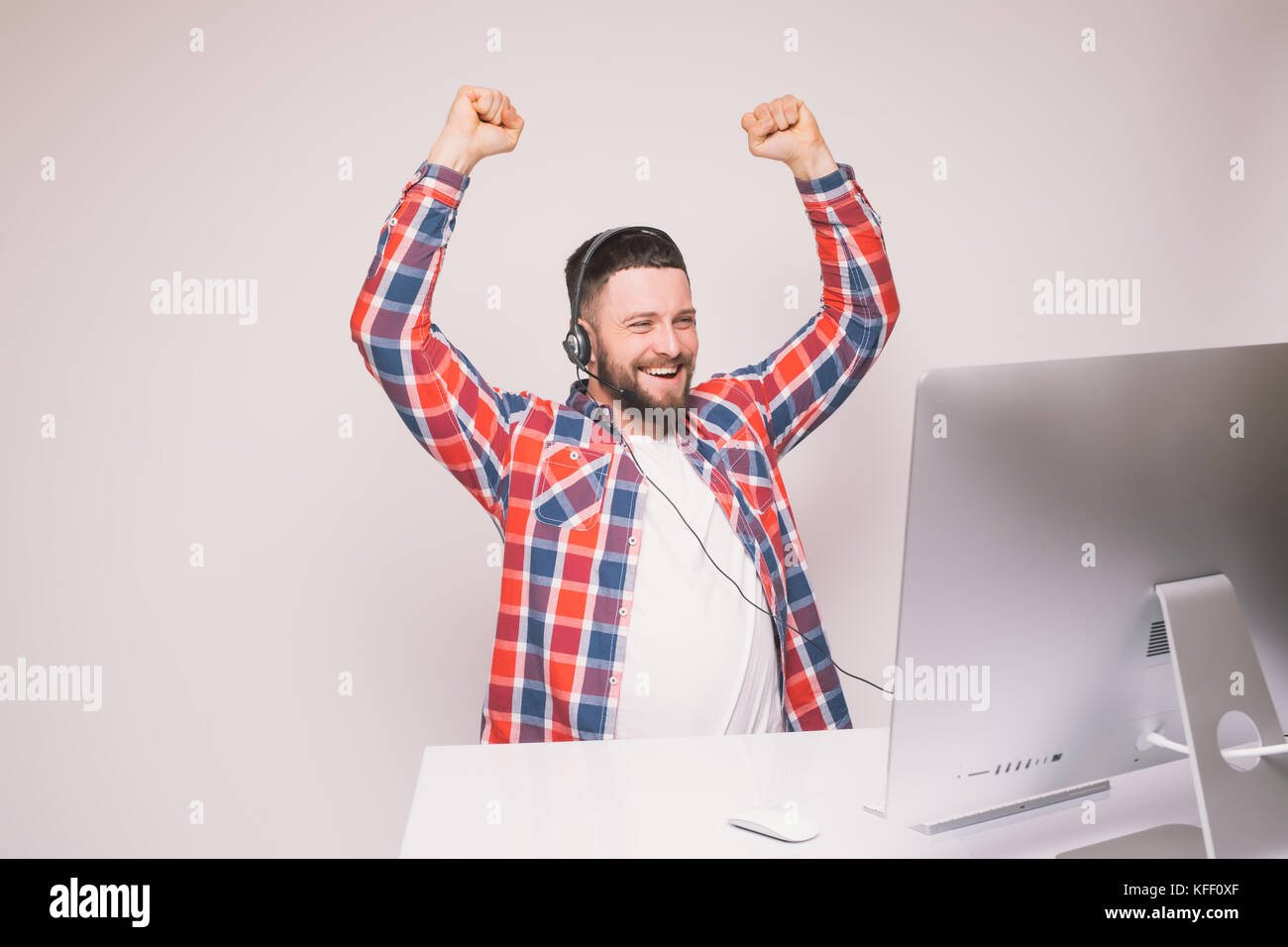 Young handsome man with happy winning emotions of victory or good news ...