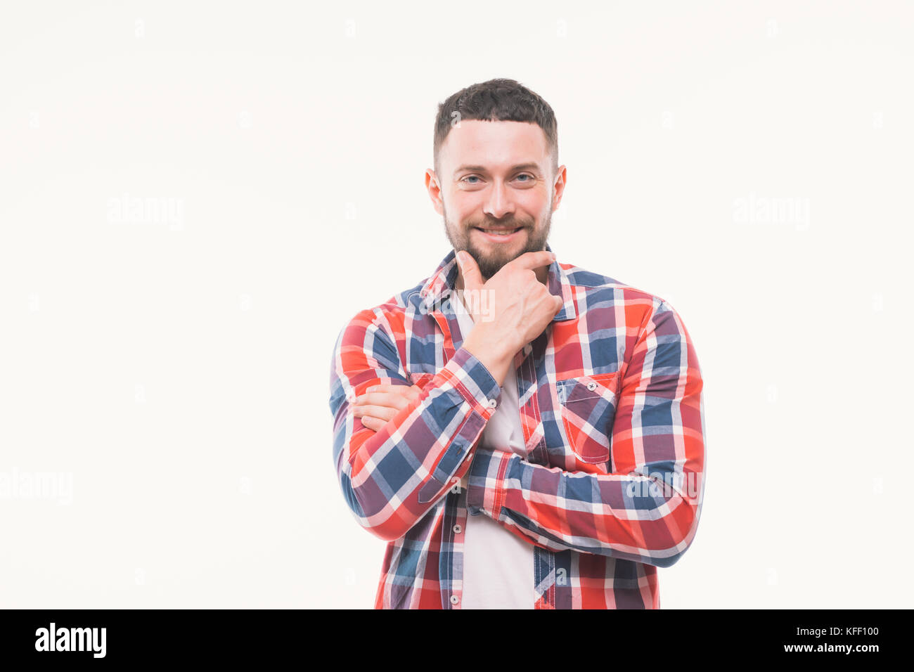 Handsome happy beard young man smiling and holding his chin, guy ...