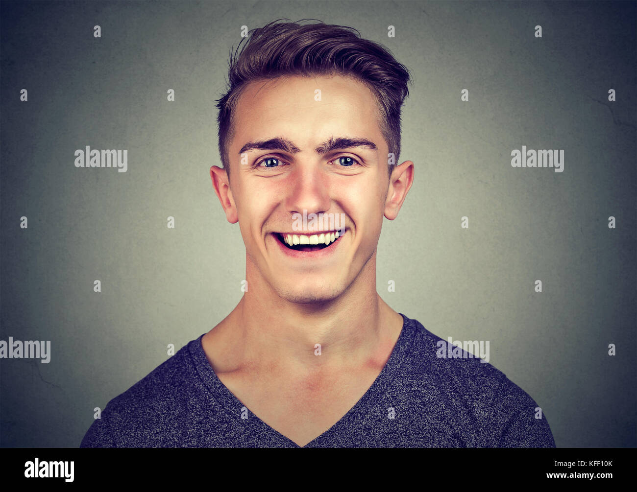 Happy man laughing isolated on gray background Stock Photo - Alamy