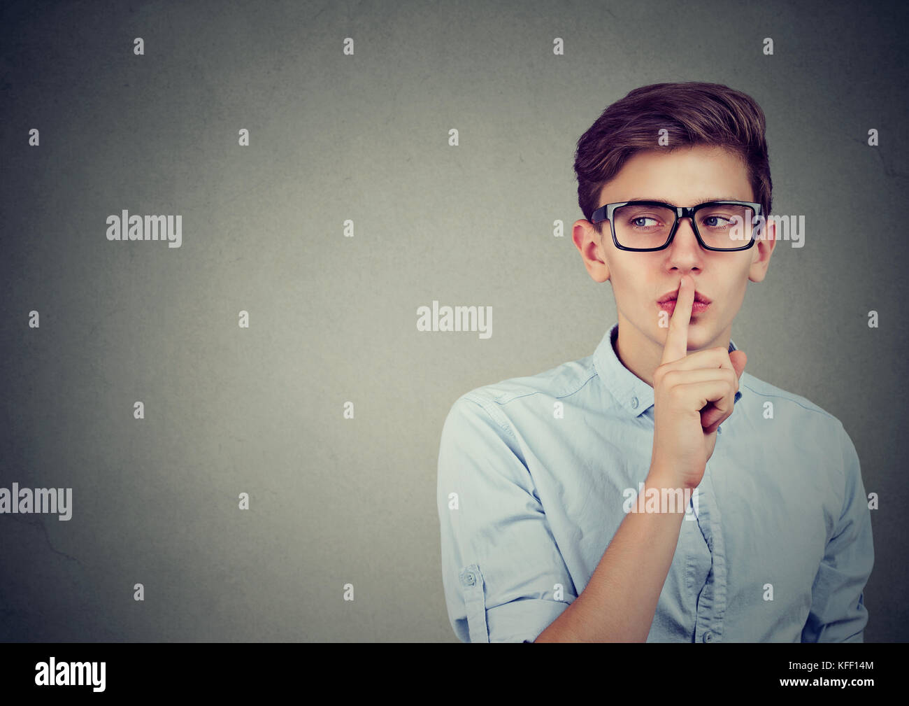 Secret guy. Man saying hush be quiet with finger on lips gesture ...