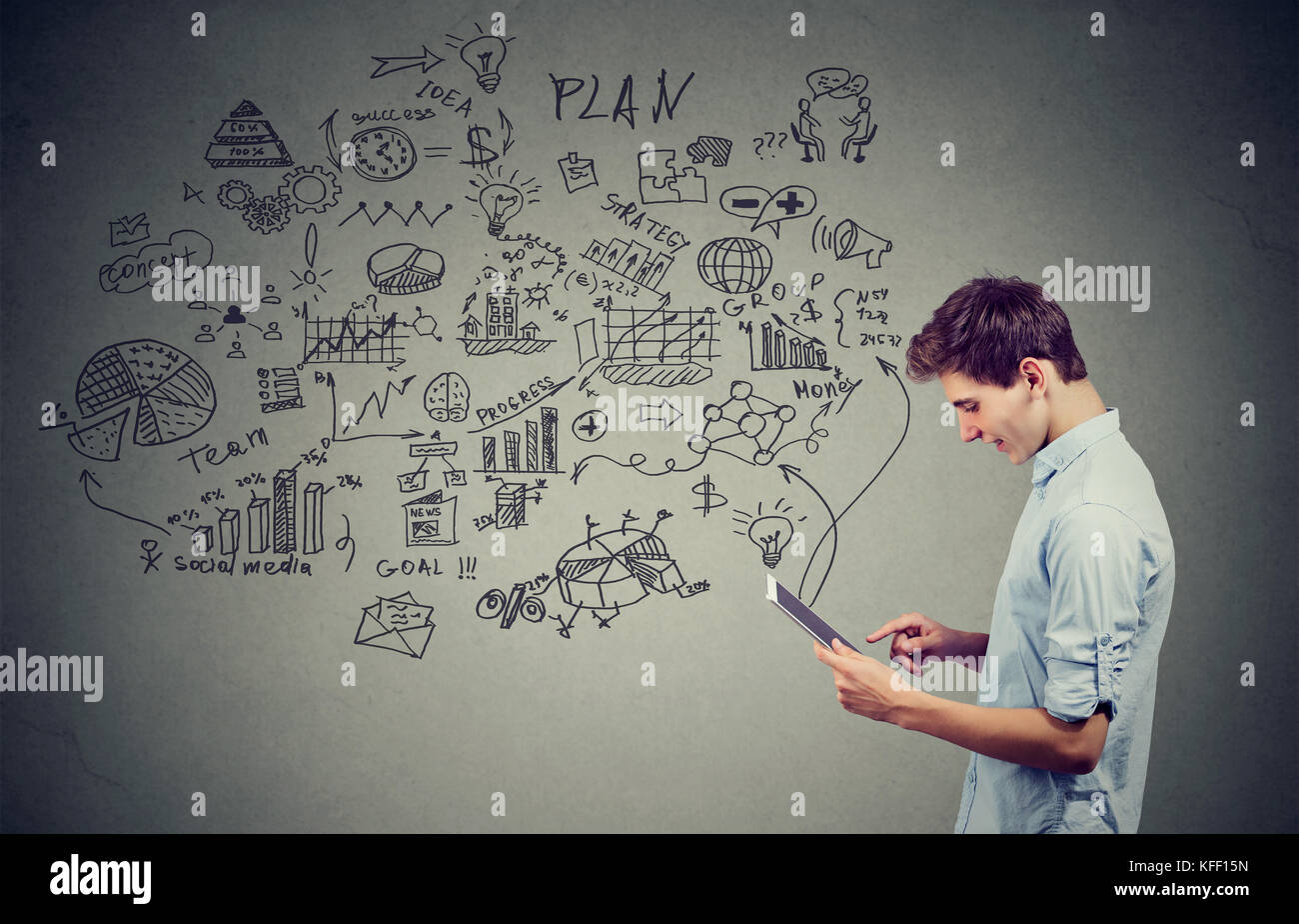 Teenager man using his tablet computer Stock Photo - Alamy