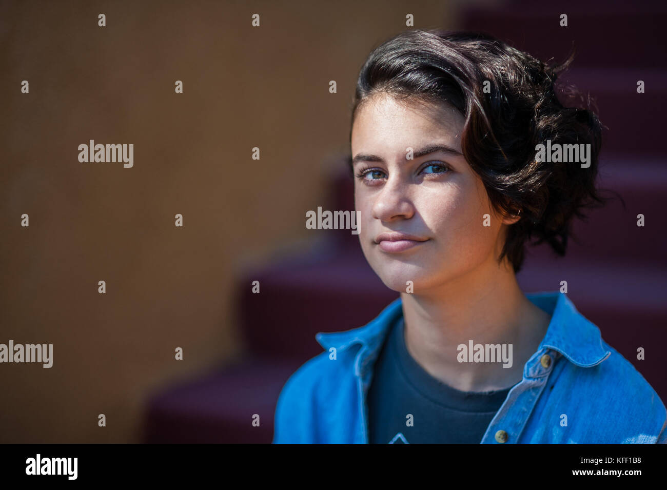 Head shot of Pretty female teen with short dark hair and serious face ...