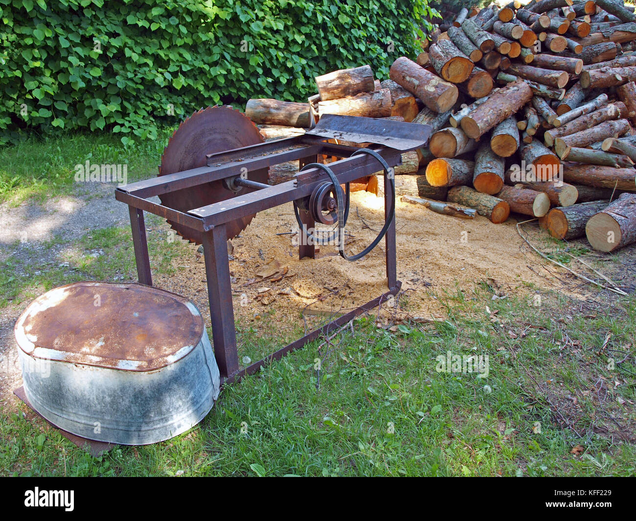 Circular saw in country yard and stack of logs Stock Photo - Alamy