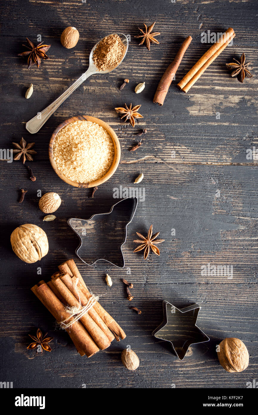 Christmas spices and baking ingredients on wooden background. Cinnamon ...
