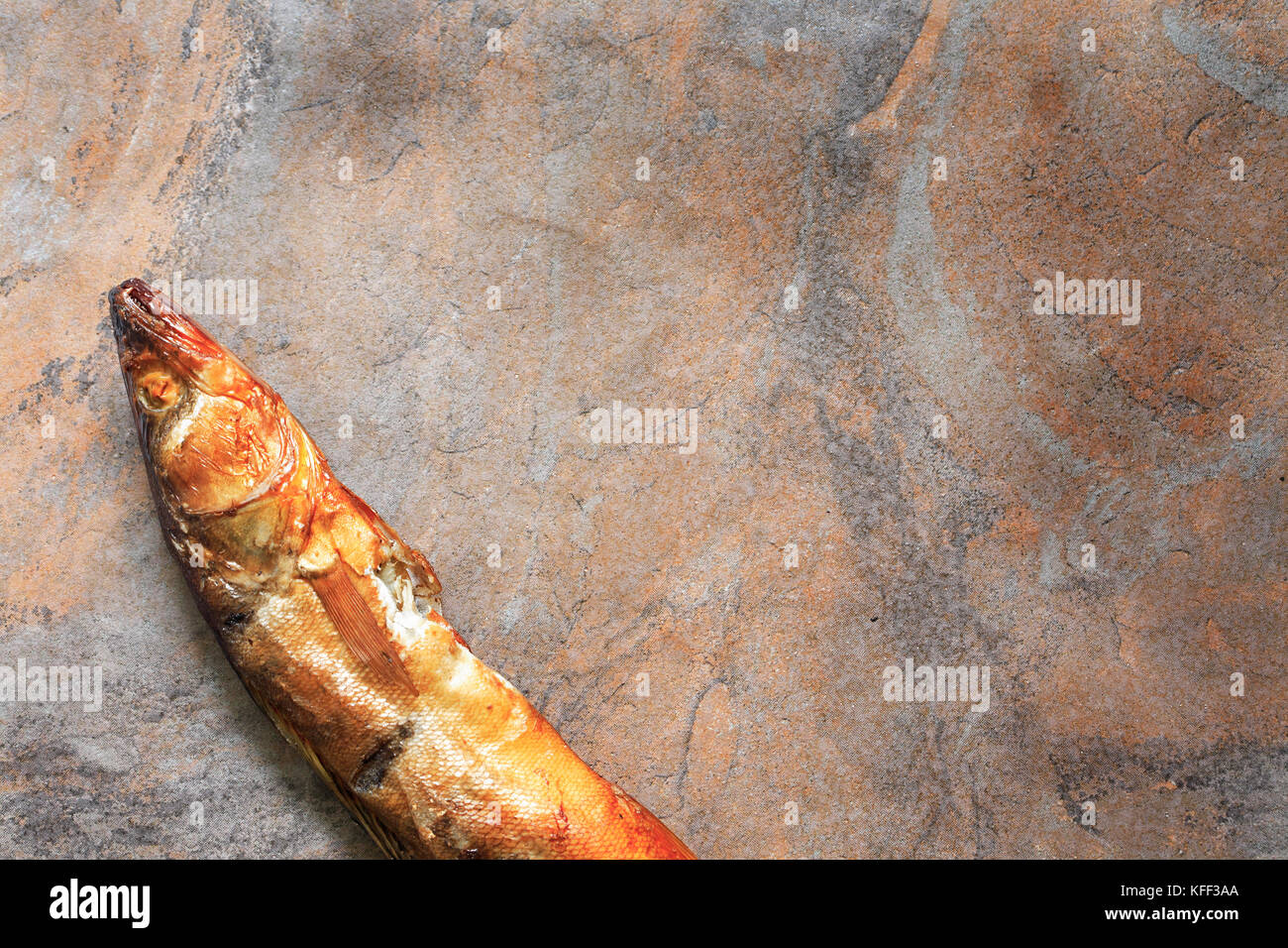 Closeup of one freshness smoked pike on stone background with free ...