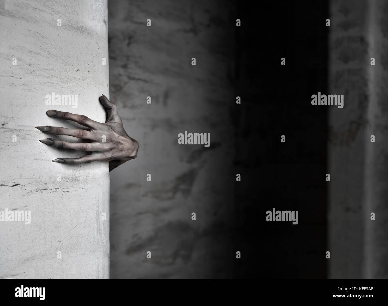 A spooky female hand protruding from behind a wall Stock Photo - Alamy