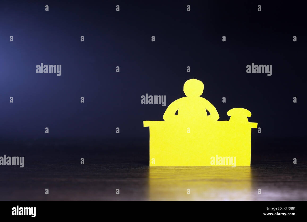 Paper man bureaucrat sitting on table against dark background Stock ...