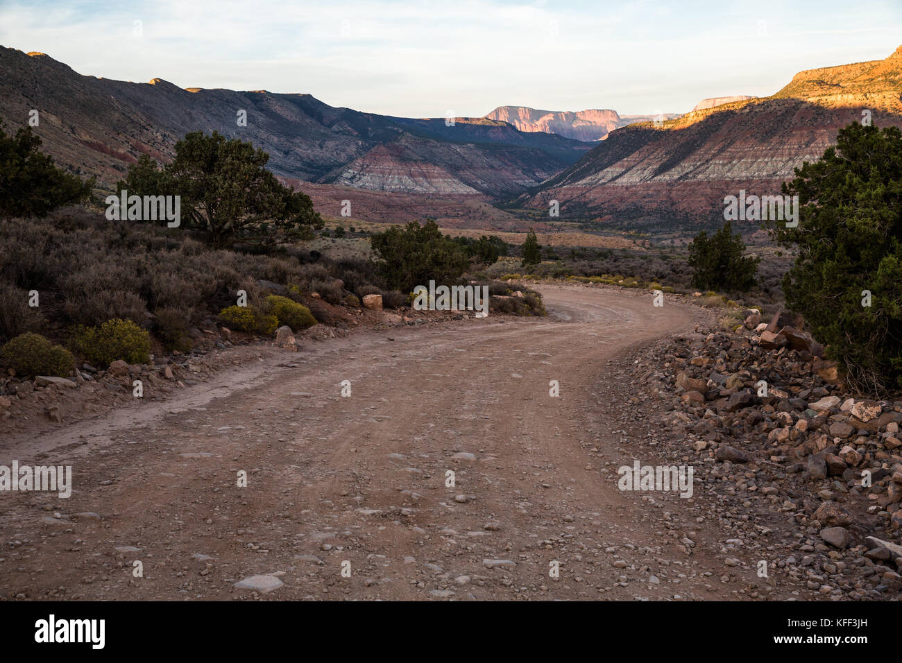 A red dirt road winds through the desert cliffs near Springdale, Utah ...