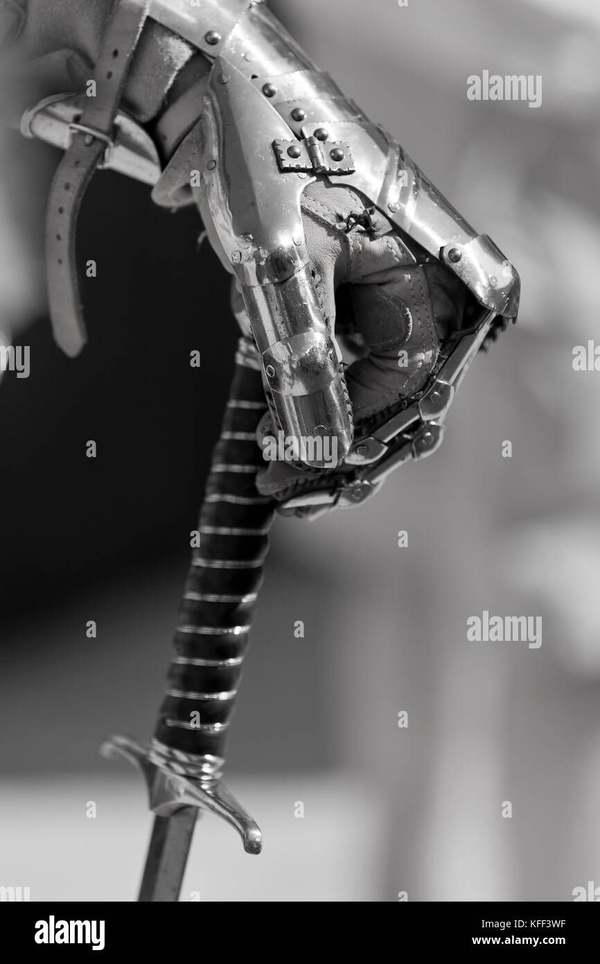 A knight's hand clutching the hilt of his sword in monochrome Stock ...