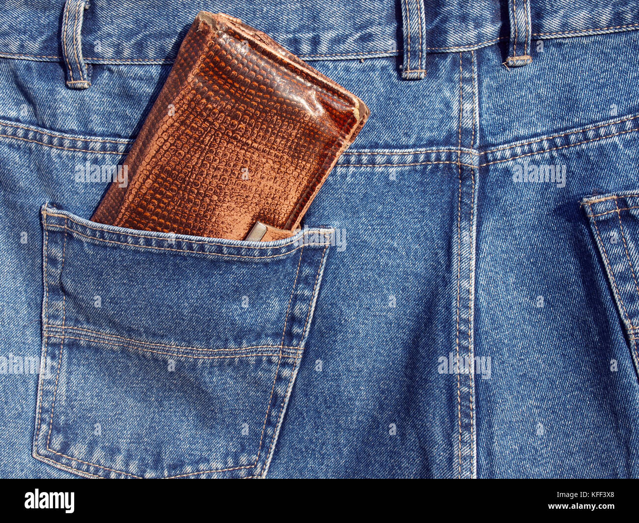 Brown wallet in jeans trousers back pocket Stock Photo - Alamy