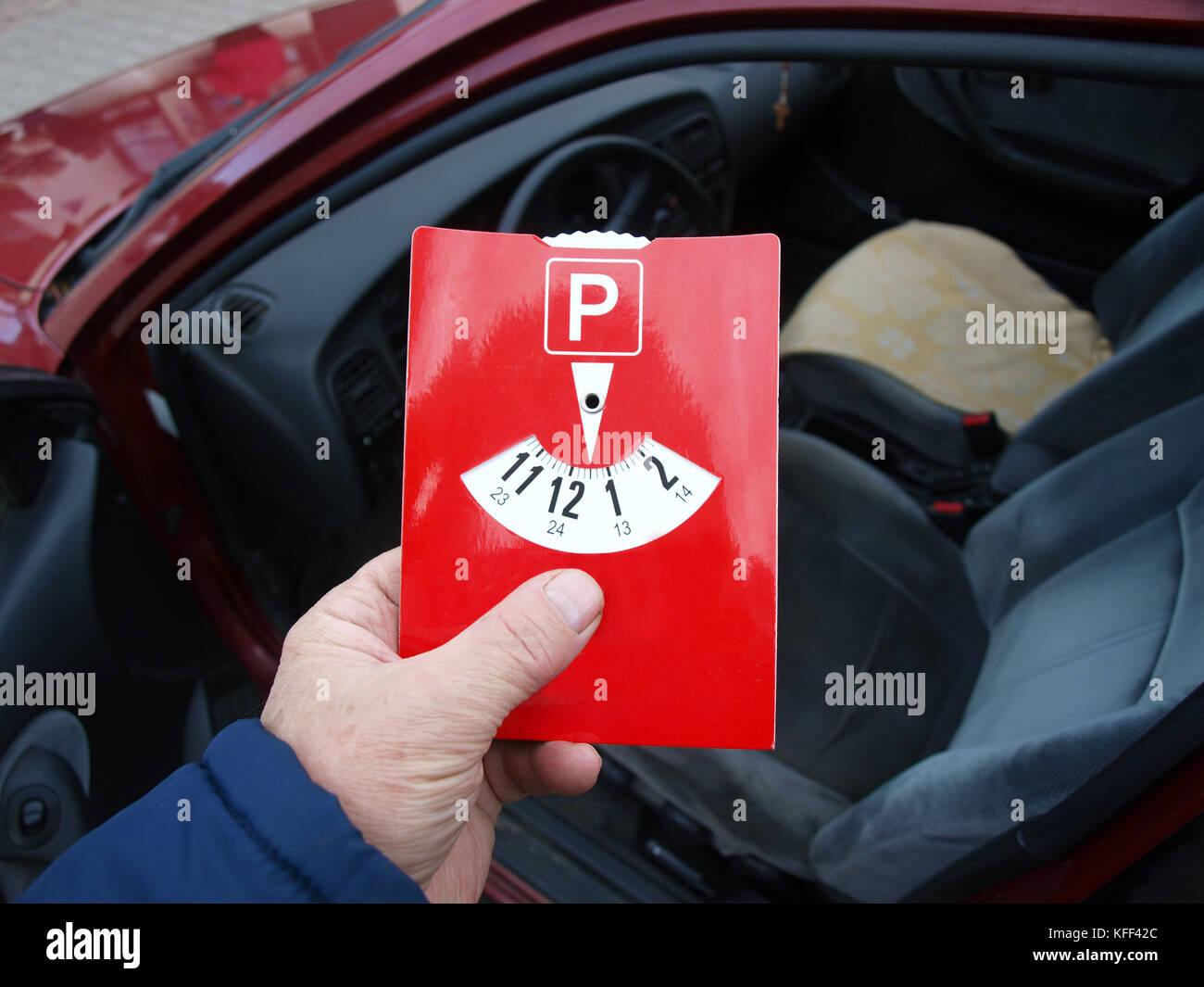 Hand holding car parking time indicator Stock Photo - Alamy