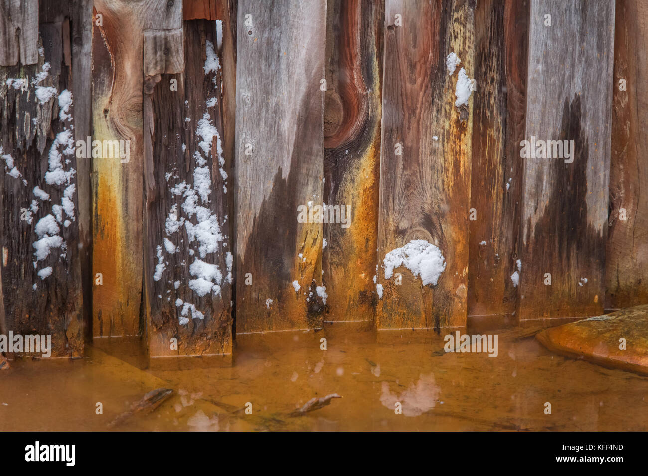 An orange rusty water at the old copper mine in Norway in winter ...