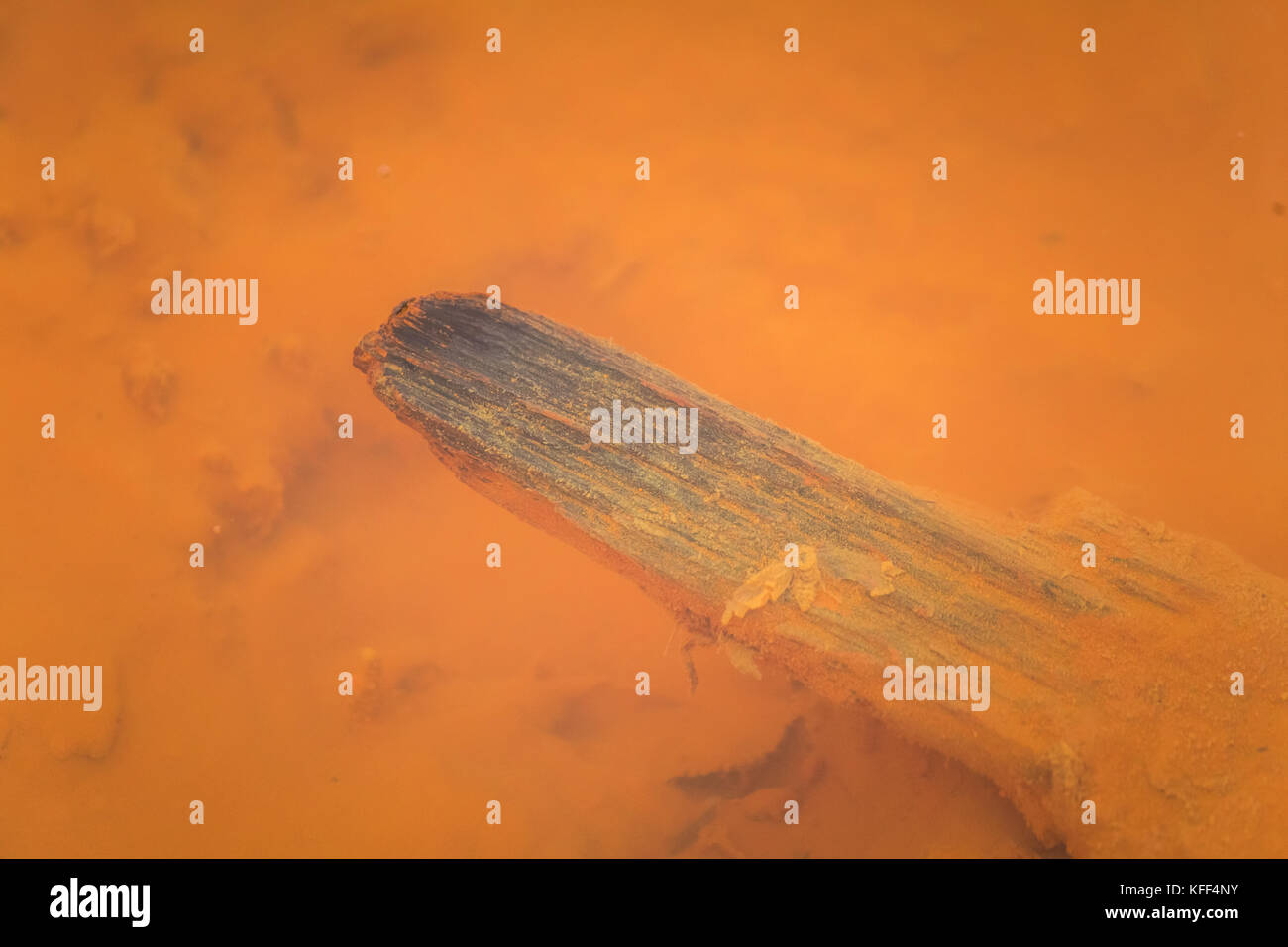 An orange rusty water at the old copper mine in Norway in winter ...