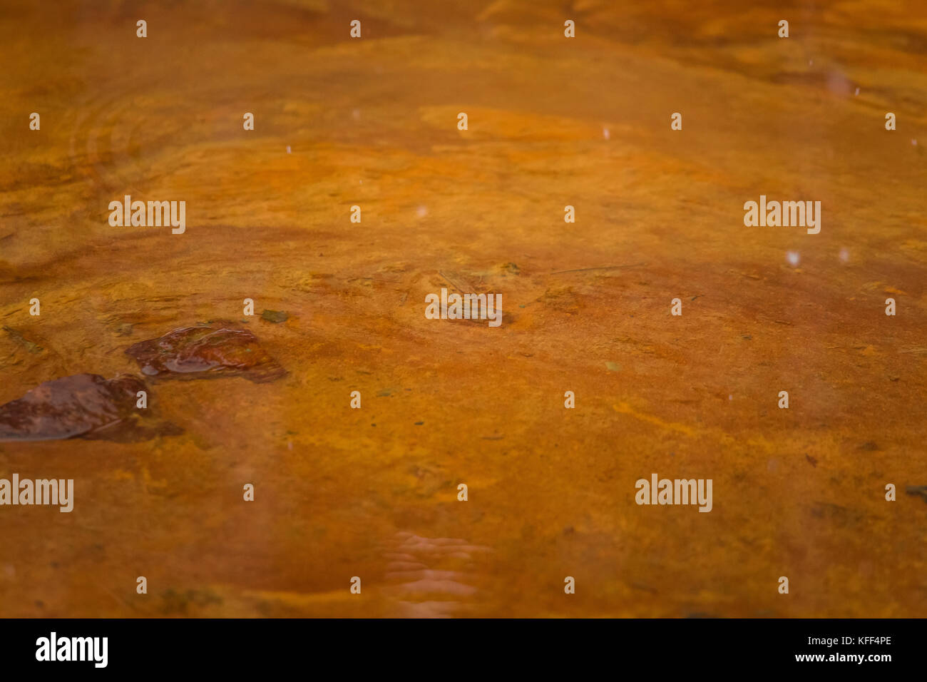 An orange rusty water at the old copper mine in Norway in winter ...