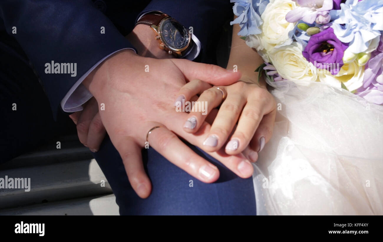Newly wed couple's hands with wedding rings. Bride and groom with ...