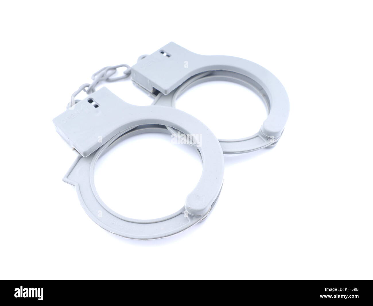 handcuffs on a white background Stock Photo - Alamy