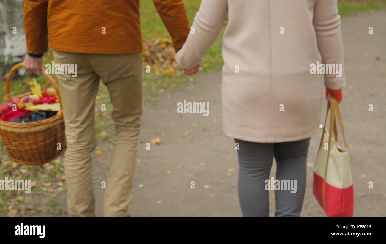 Couple in love walk in the park and hold hands. Lovers holding their ...