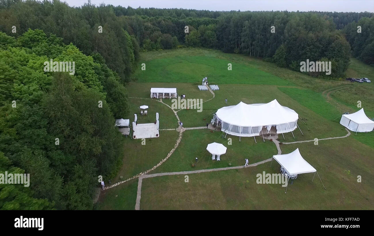 Beautiful bride and groom embrace on field background. Aerial view on ...