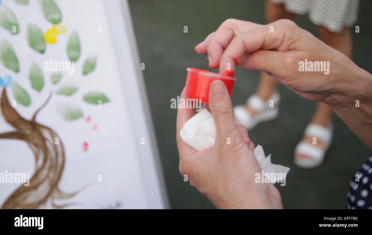 Hands doing Fingerpainting with various colors. Woman's hand draws ...