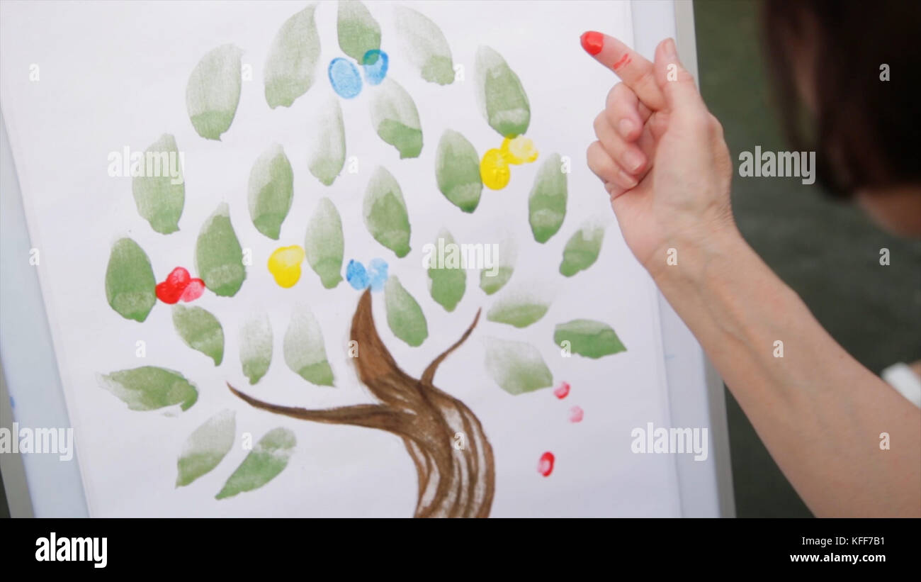 Hands doing Fingerpainting with various colors. Woman's hand draws ...