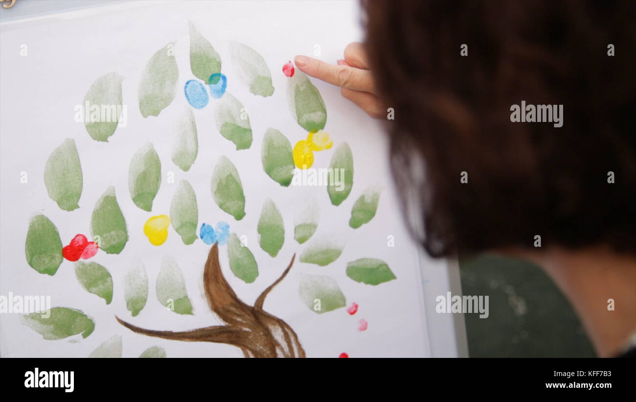 Hands doing Fingerpainting with various colors. Woman's hand draws ...