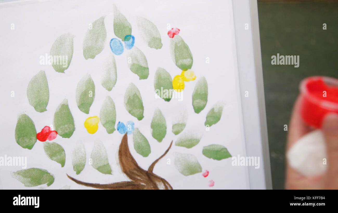 Hands doing Fingerpainting with various colors. Woman's hand draws ...