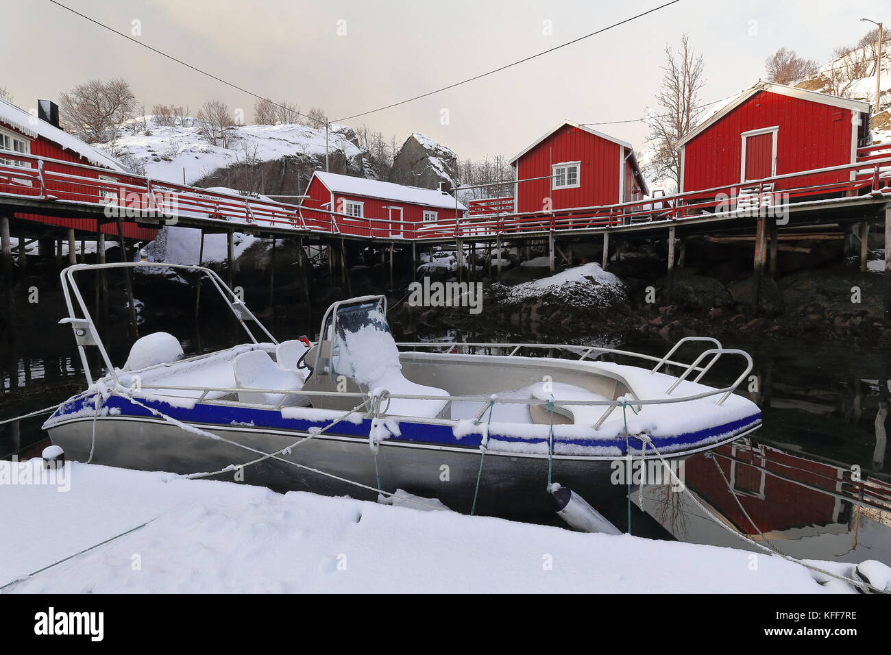 Snow covered harbor of Nusfjord fishing village with floating pontoons ...