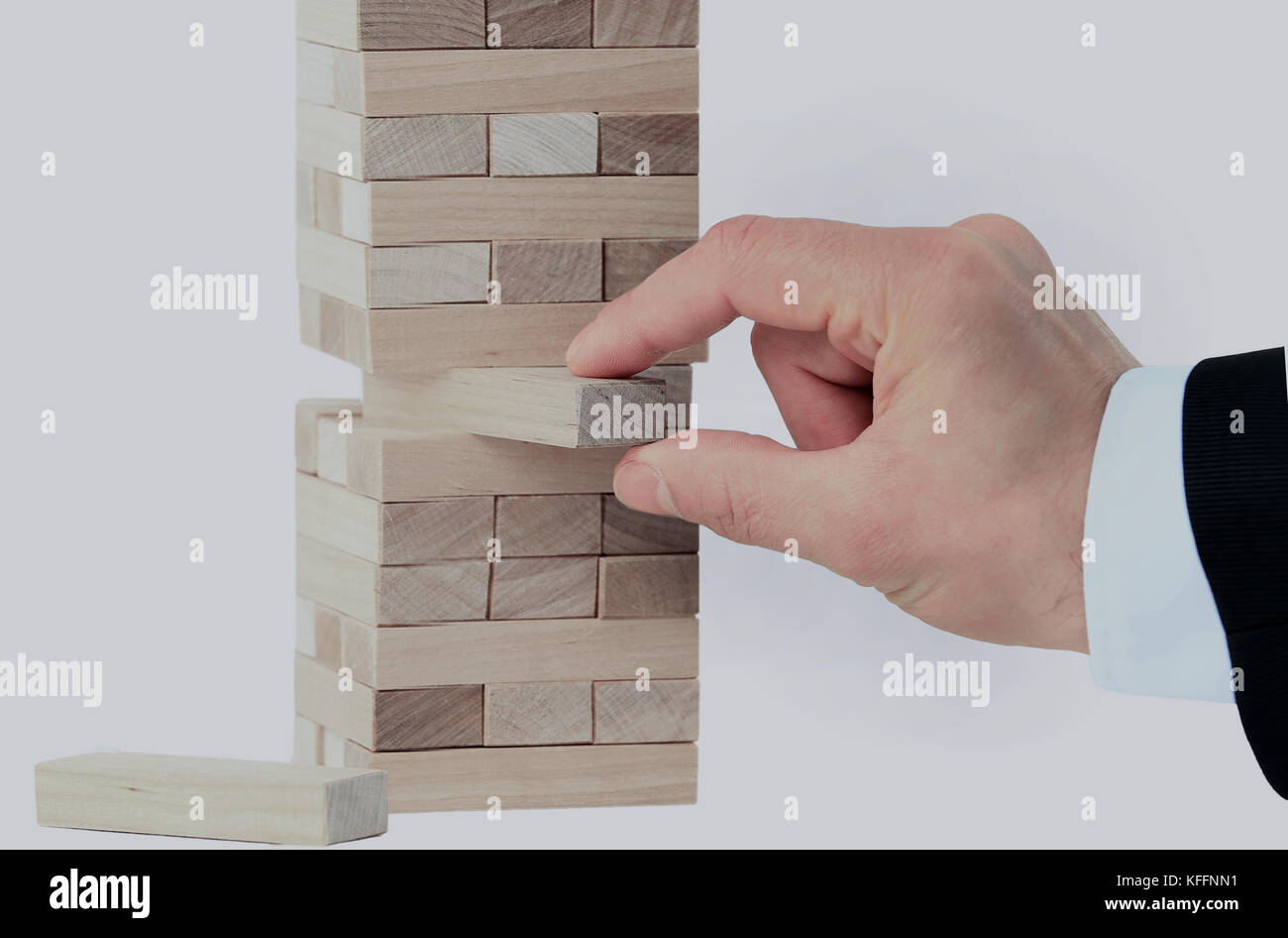 Closeup hand man take one block on the tower from wooden blocks Stock ...