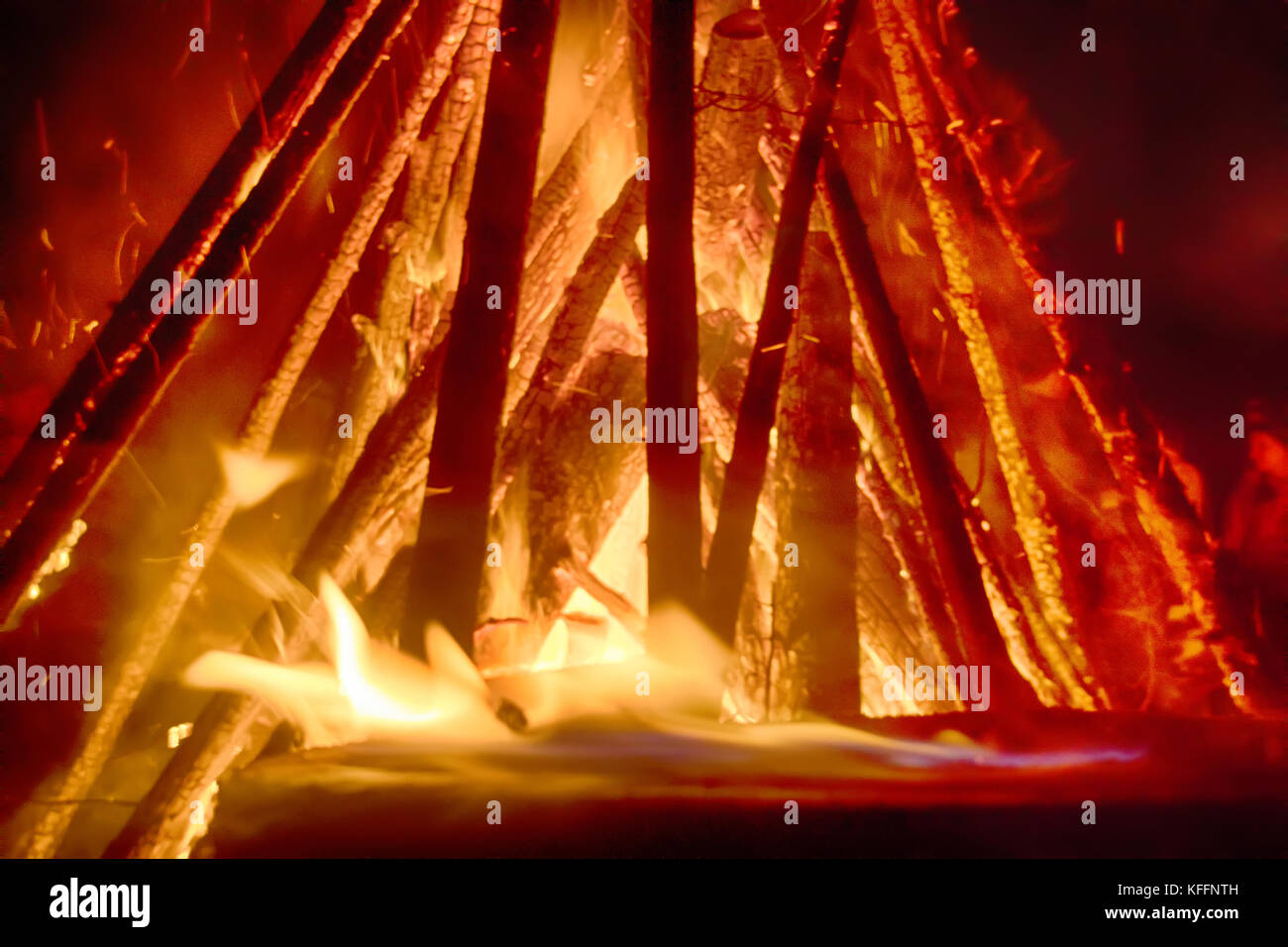 Huge fire at night and young people around. Pagan festival of Walpurgis ...