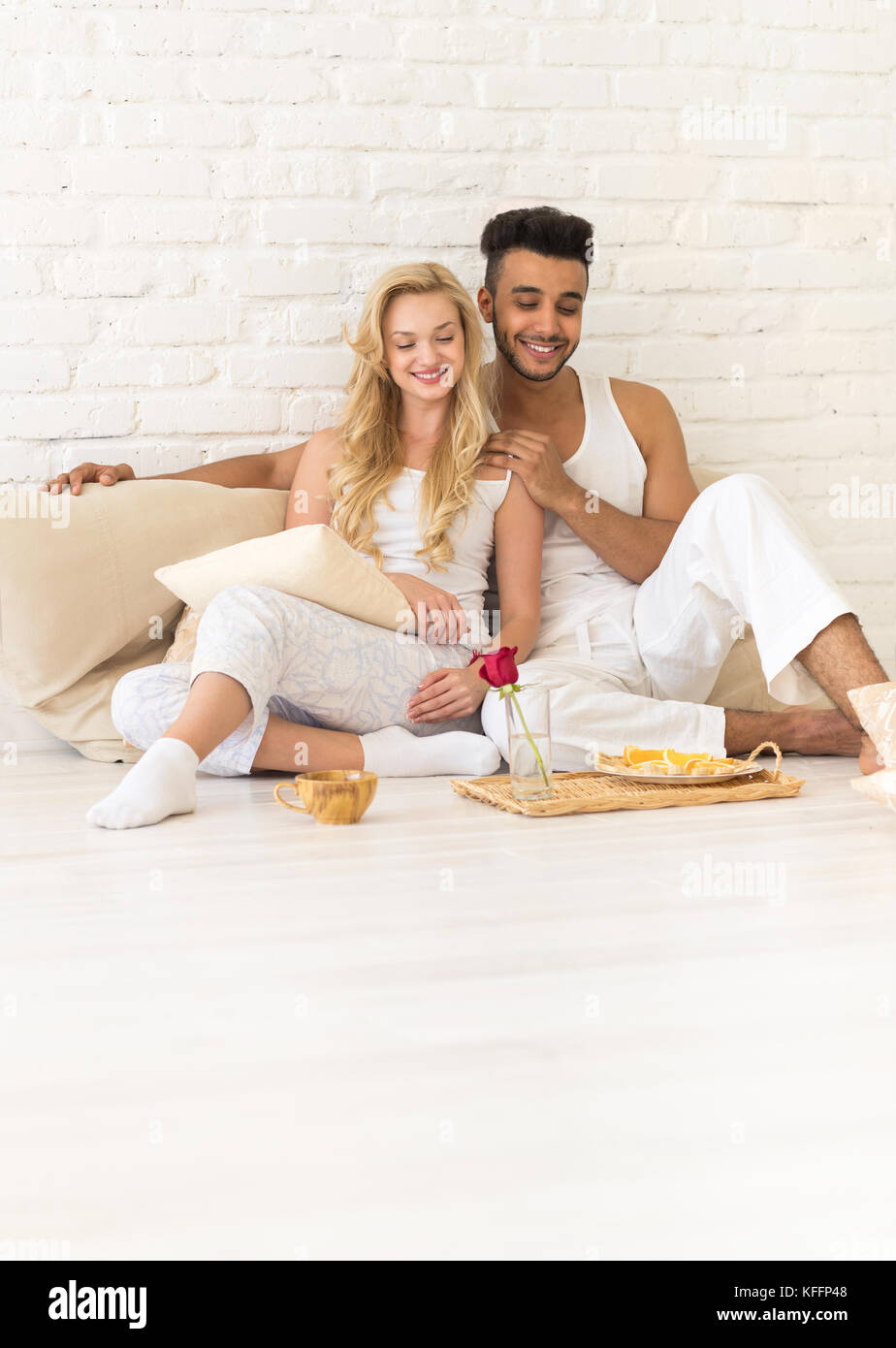 Young Couple Sit On Pillows Floor, Happy Hispanic Man And Woman ...