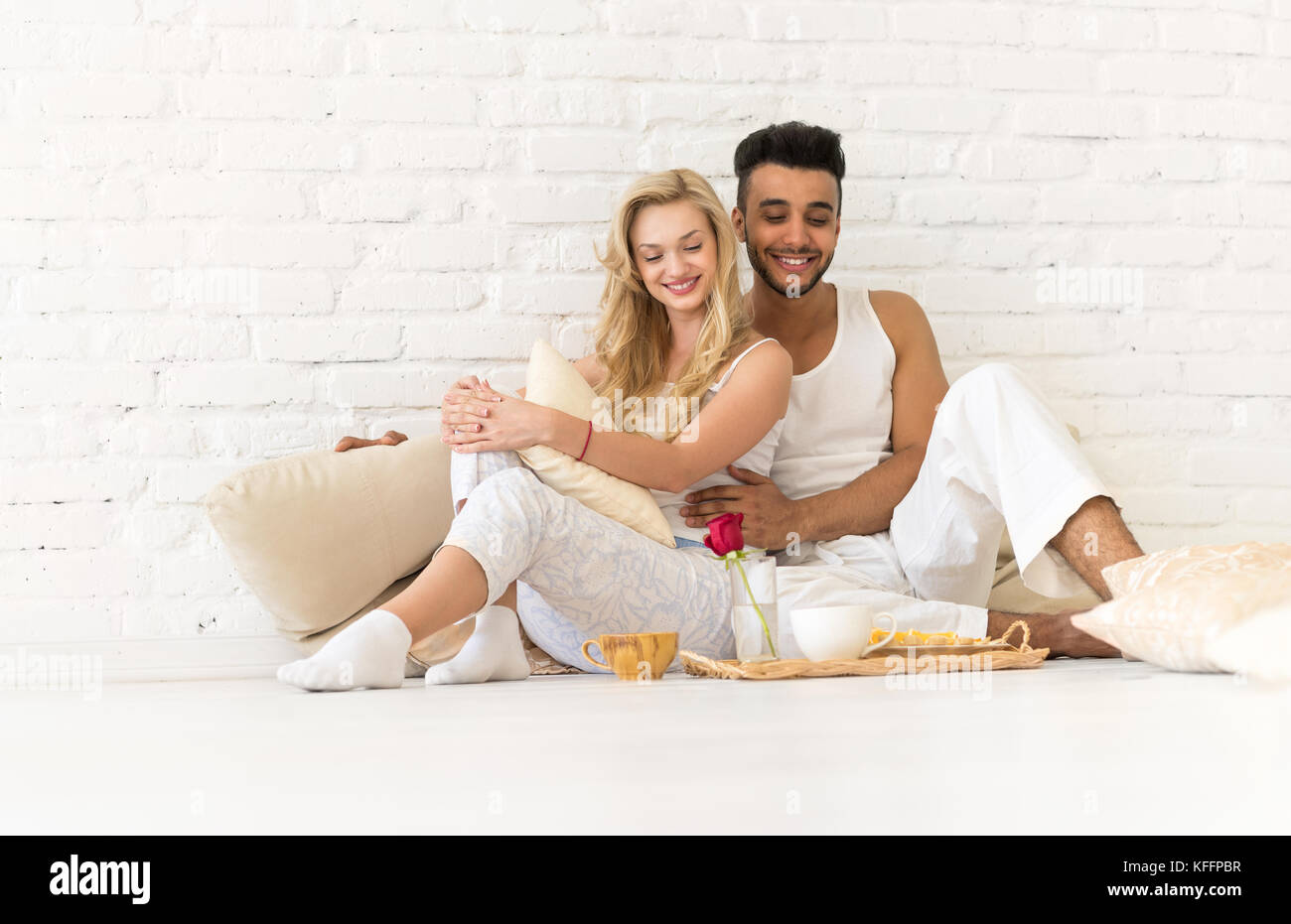 Young Couple Sit On Pillows Floor, Happy Hispanic Man And Woman ...