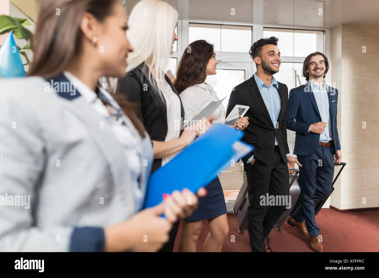 Hotel Receptionist Meeting Business People Group In Lobby Stock Photo ...
