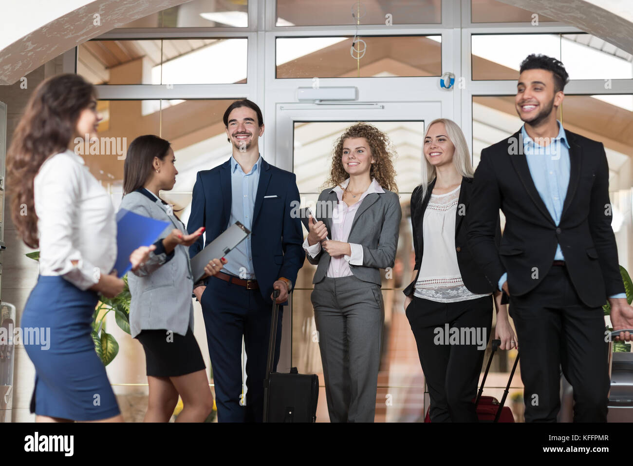 Hotel Administrator Welcome Business People In Lobby, Mix Race ...