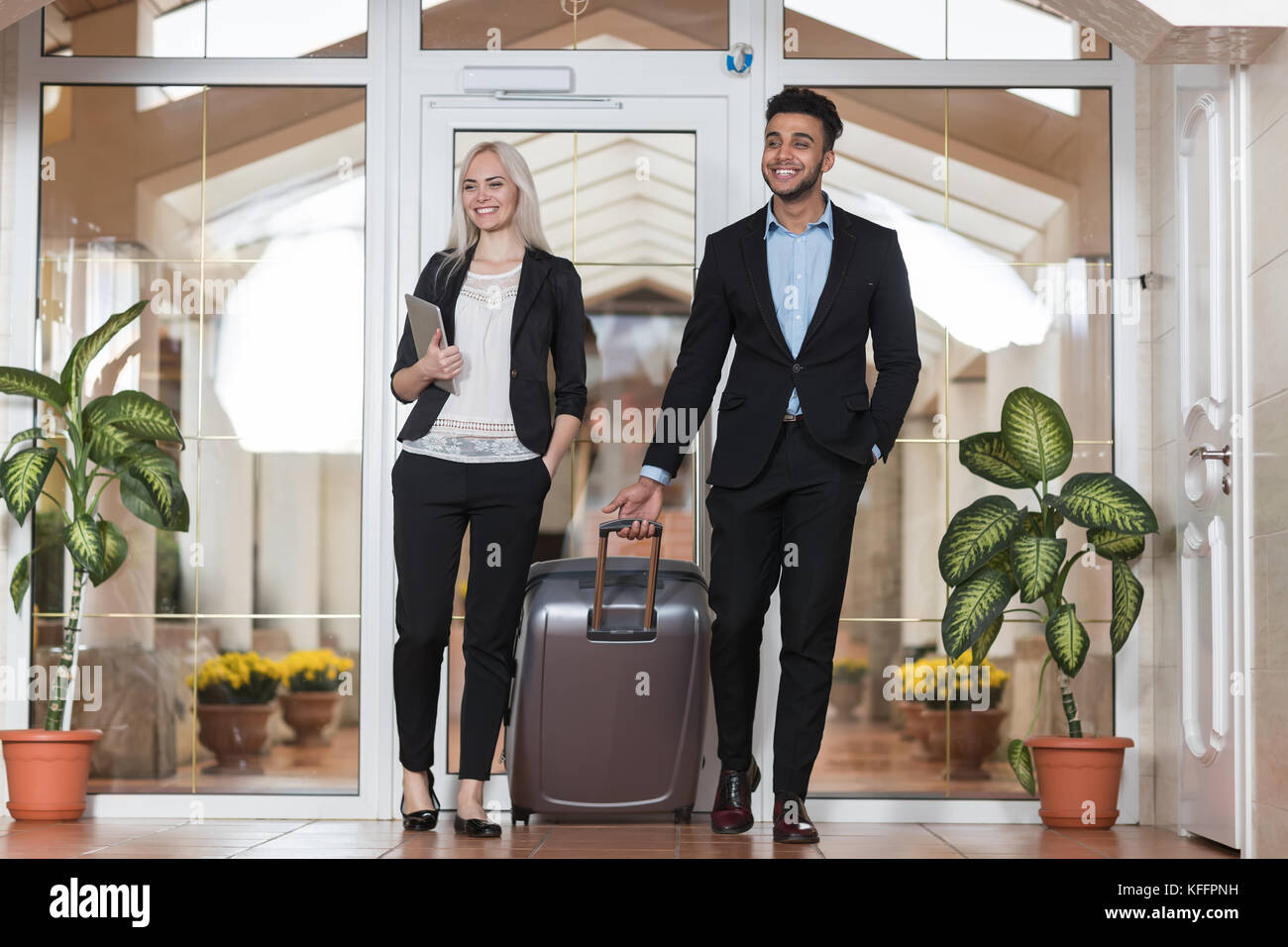 Guests arrive suitcase hi-res stock photography and images - Alamy