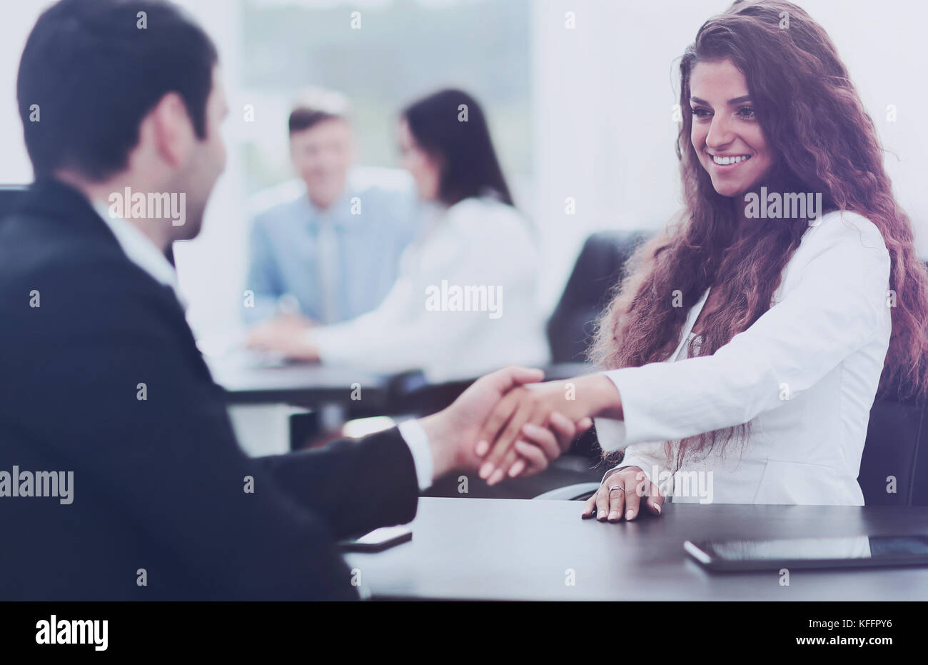 Business meeting at the table with handshake Stock Photo - Alamy