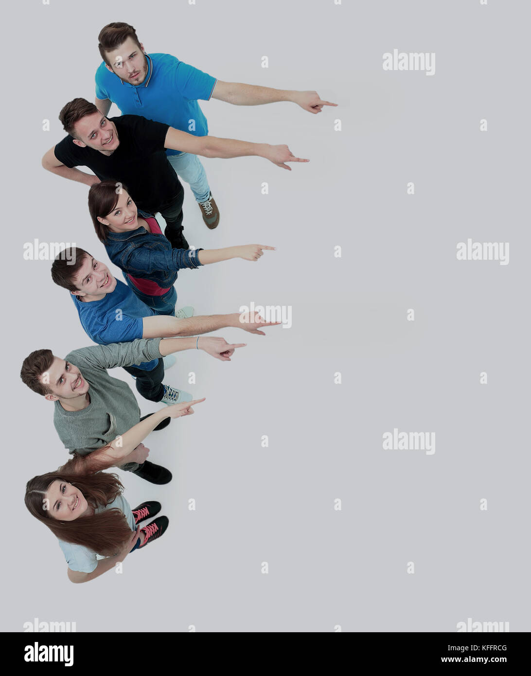 group of young people pointing at something Stock Photo - Alamy