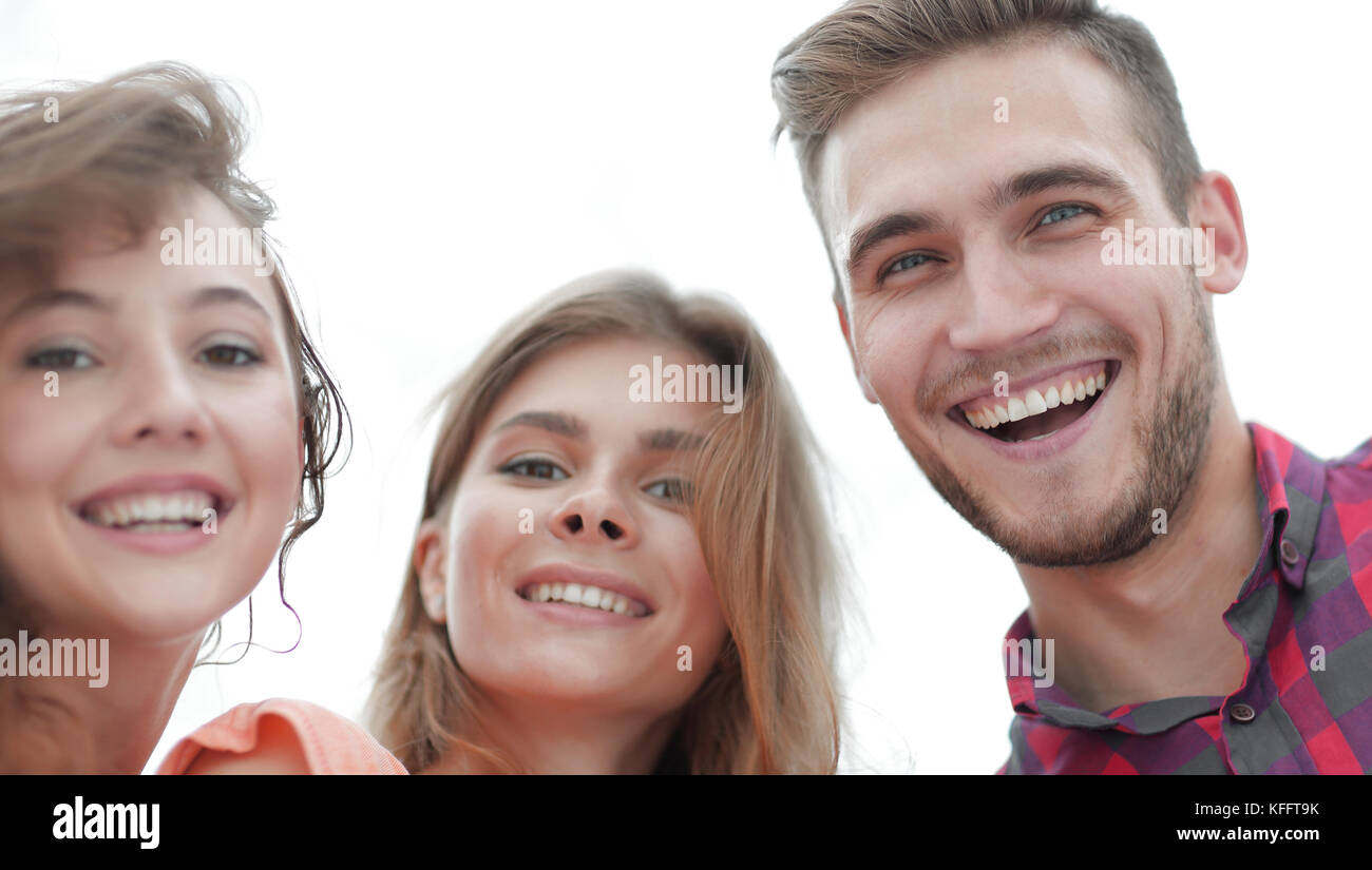 closeup of three happy young people smiling over white background Stock ...