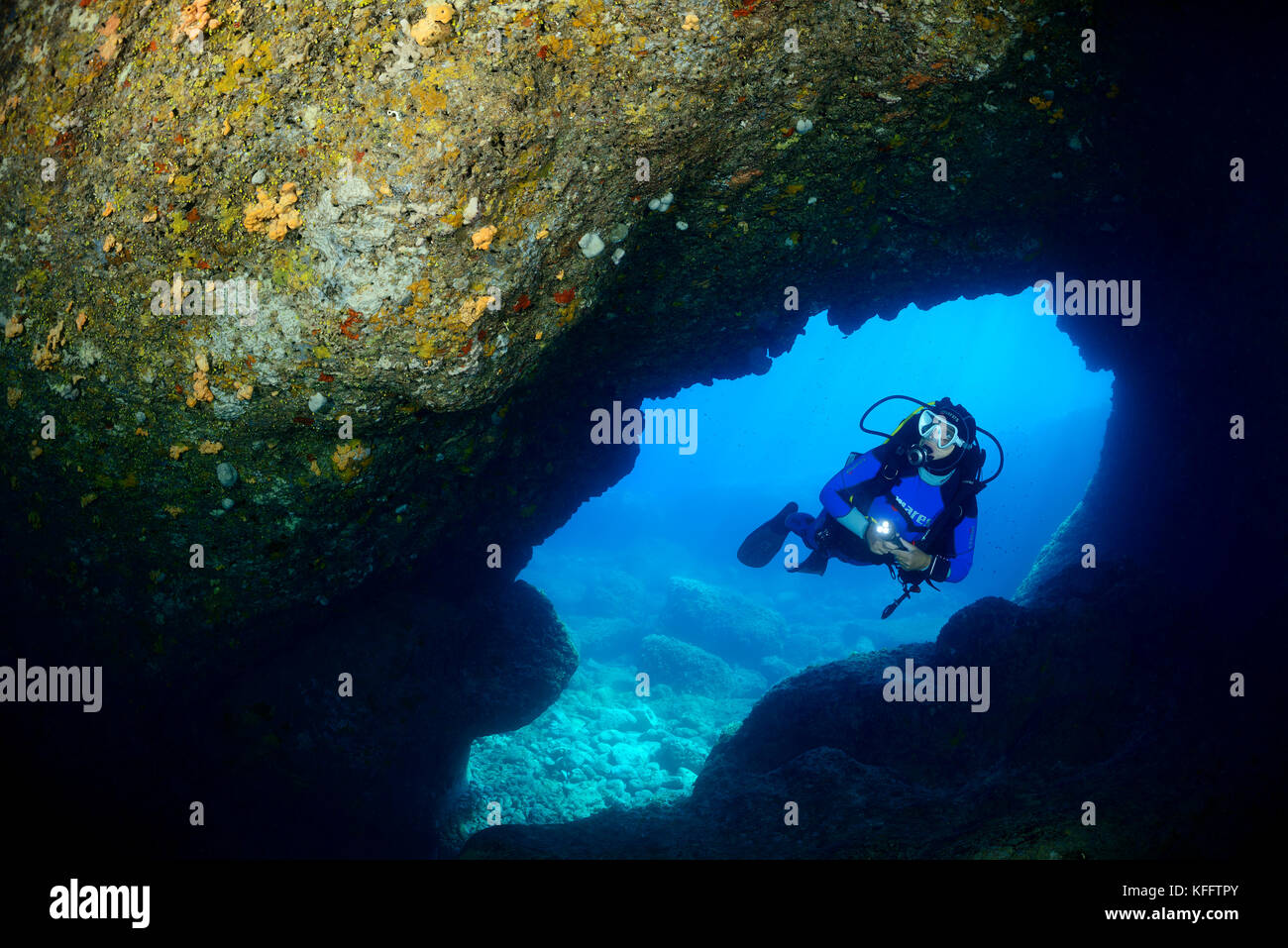 Suba diver on the entrance of a cave, Adriatic Sea, Mediterranean Sea ...