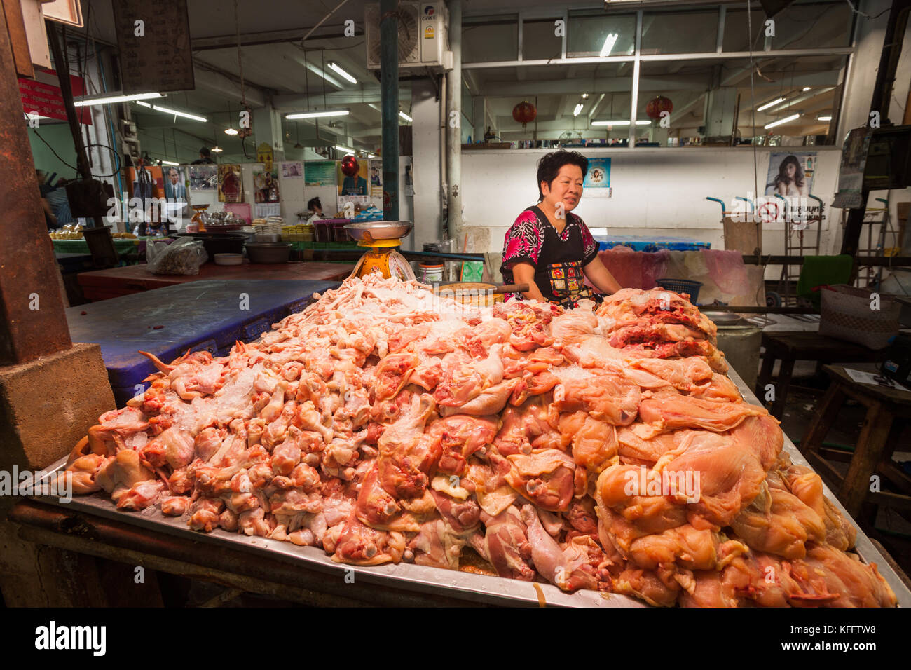 A woman meat seller with a large pile of meat at Warorot Market, Chiang ...