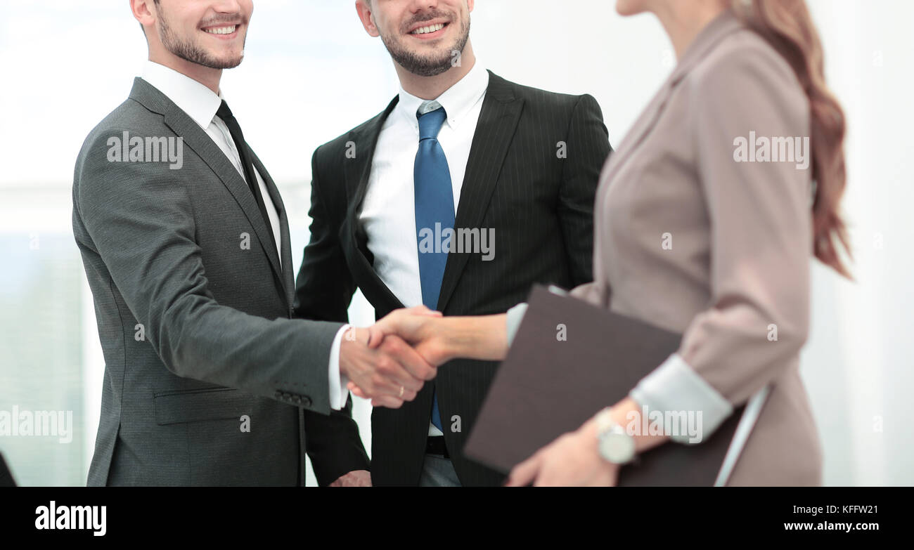 Handshake between business people in a modern office Stock Photo - Alamy