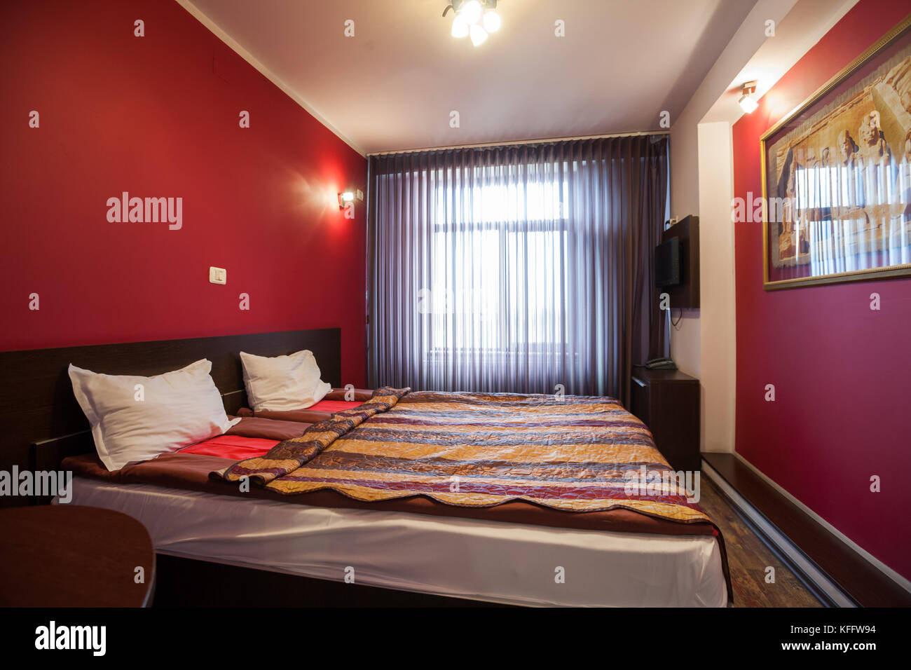 Upscale hotel room with red decor Stock Photo - Alamy