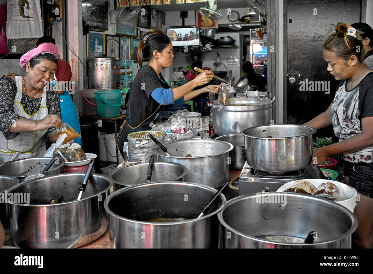 People Cooking Food In The Kitchen