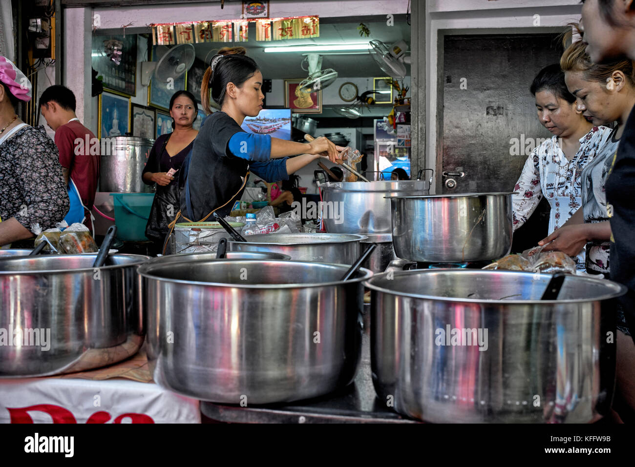 People Cooking Food In The Kitchen