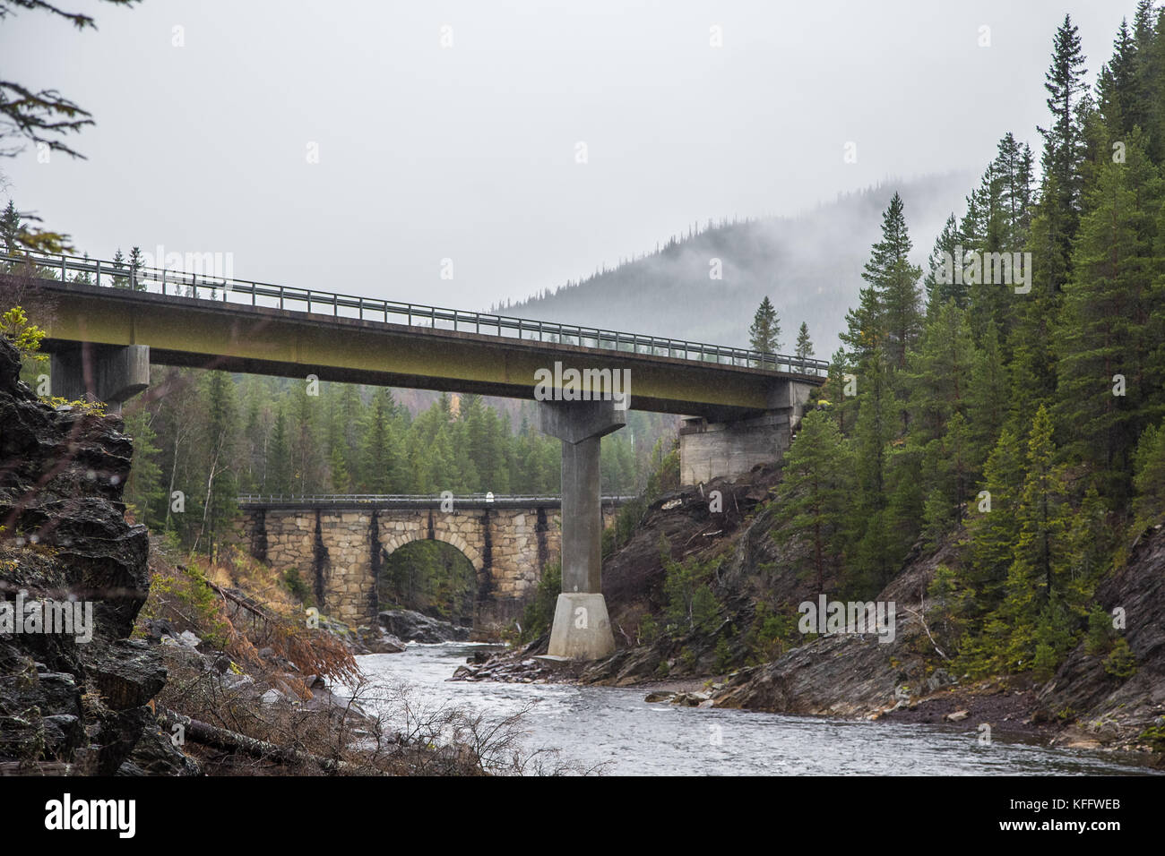 A beautiful historic stone bridge crossing the river in central Norway ...